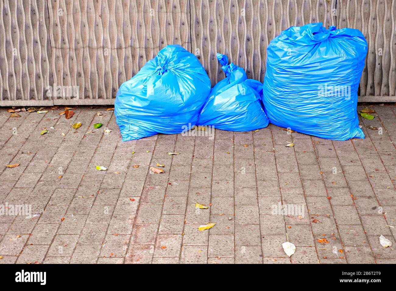 Three blue plastic bags filled with content Stock Photo - Alamy