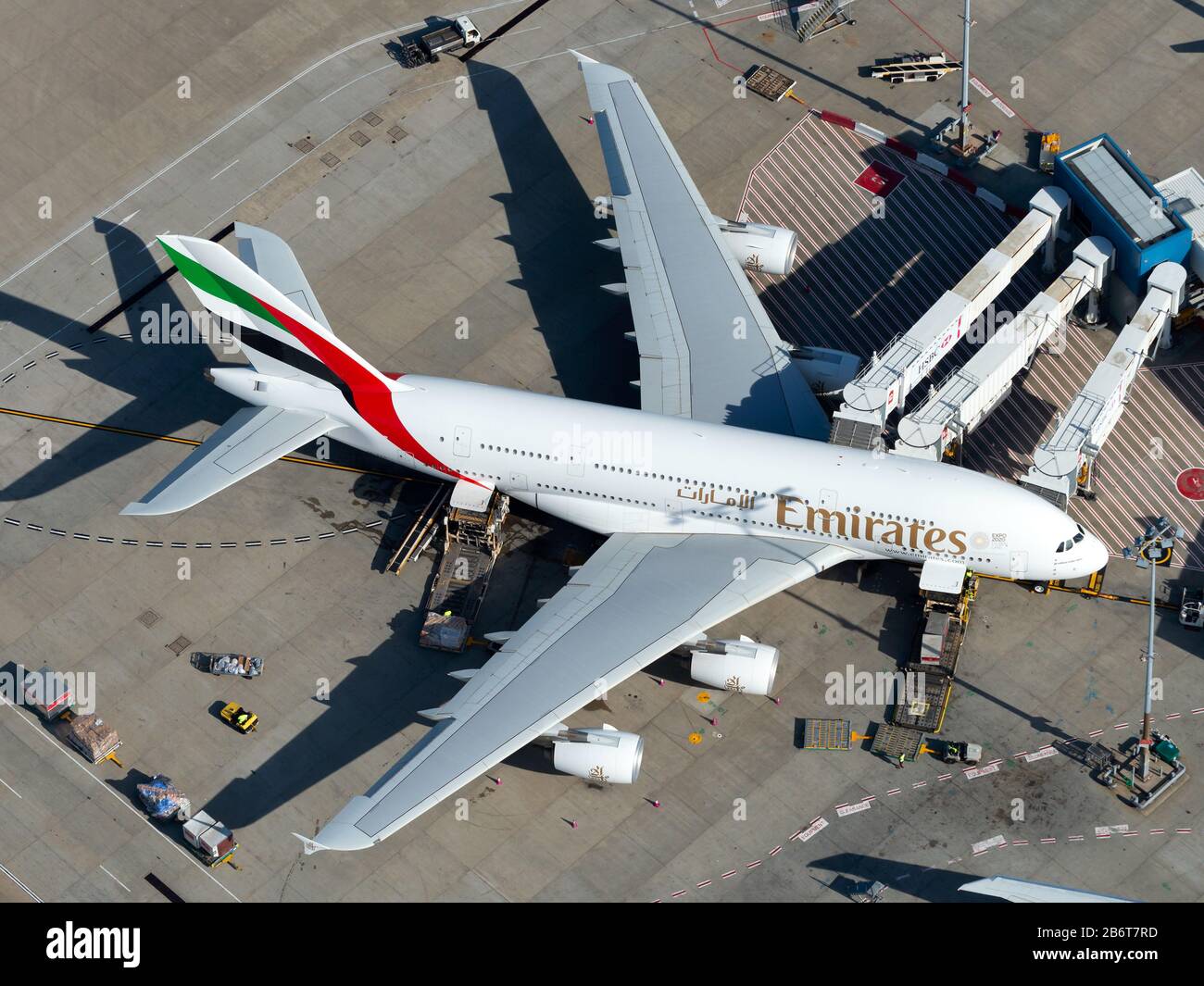 Emirates Airline Airbus A380 parked at airport terminal after arrival ... Emirates Airline Airbus A380 parked at airport terminal after arrival ...