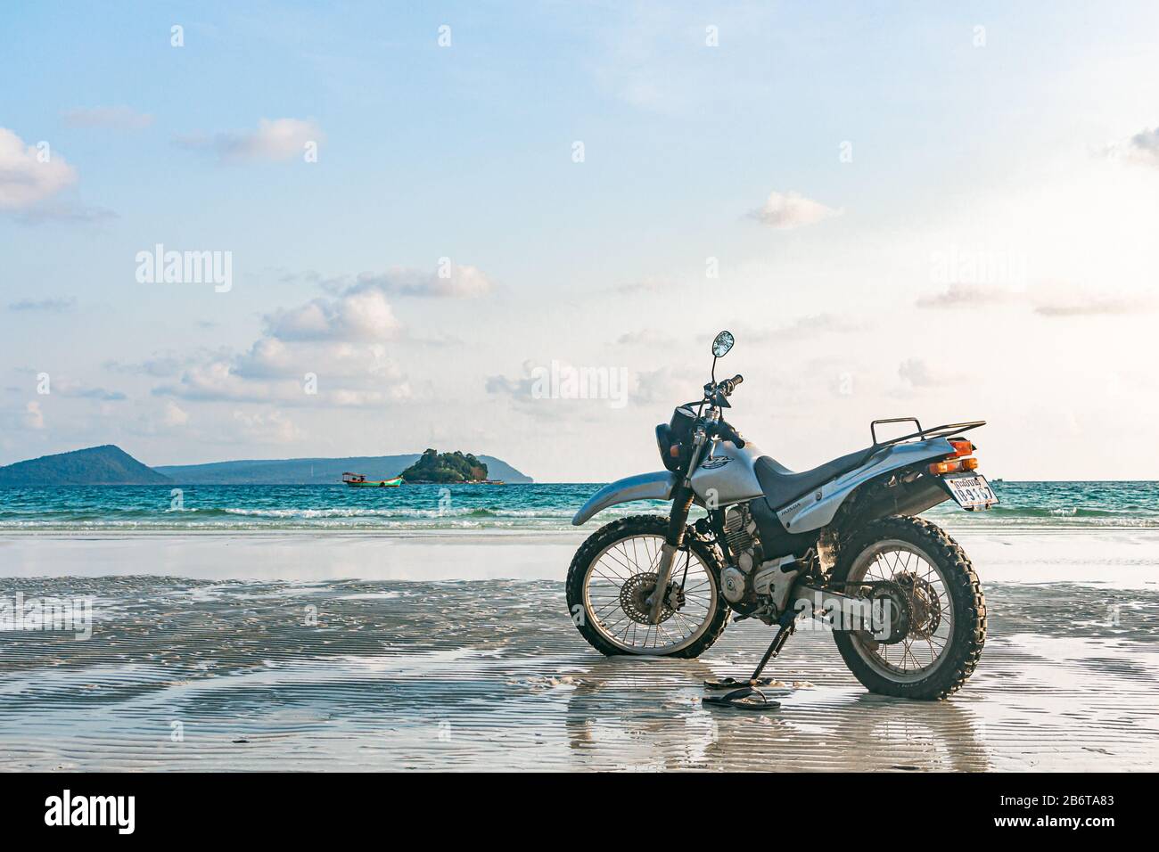 A silver motorcycle is standing at the beach Stock Photo - Alamy