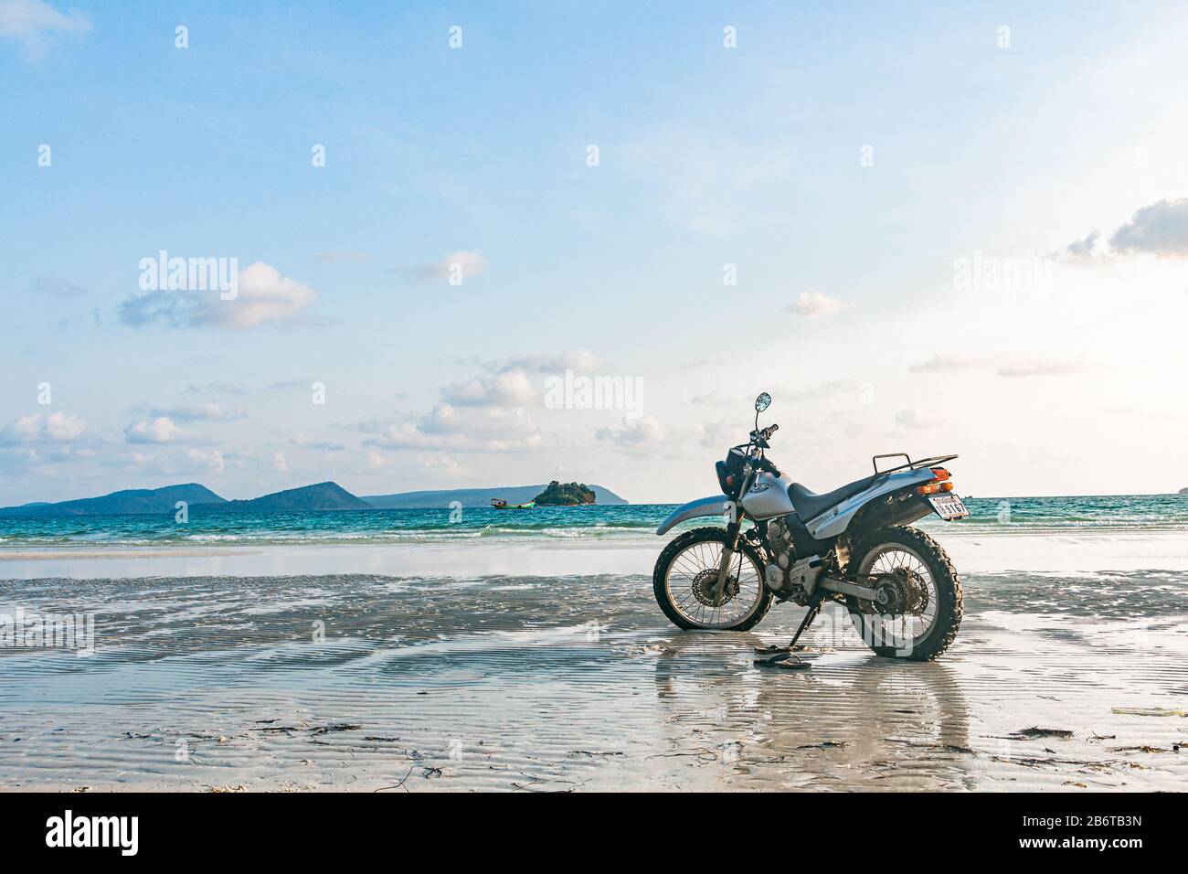 A silver motorcycle is standing at the beach Stock Photo - Alamy