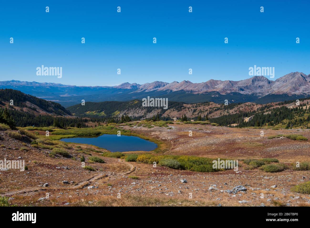 Landscape of small pond, greenery and mountain tops at Cottonwood Pass ...