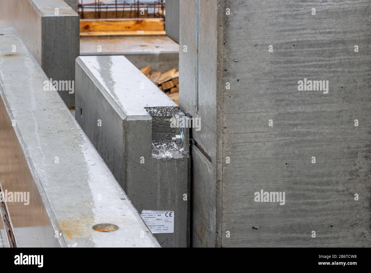 On a large construction site, concrete cross beams are connected to ...