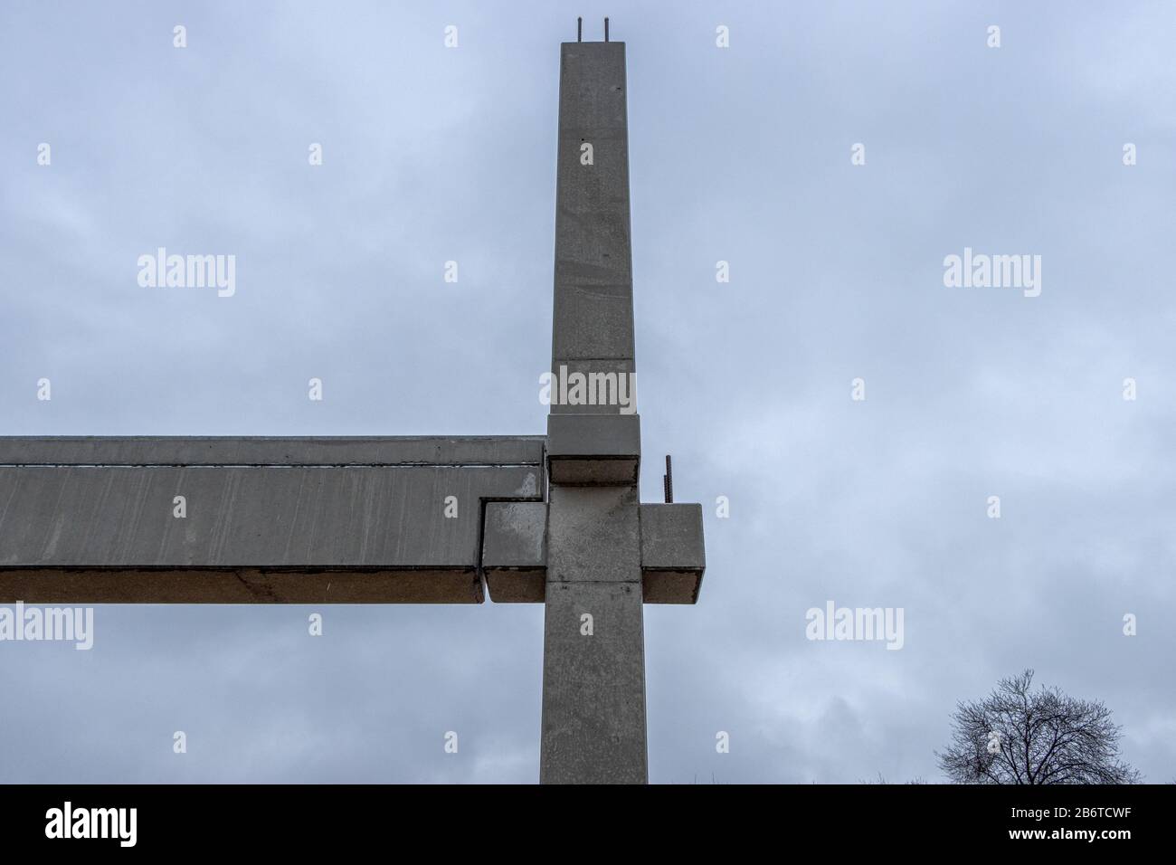 On a large construction site, concrete cross beams are connected to ...