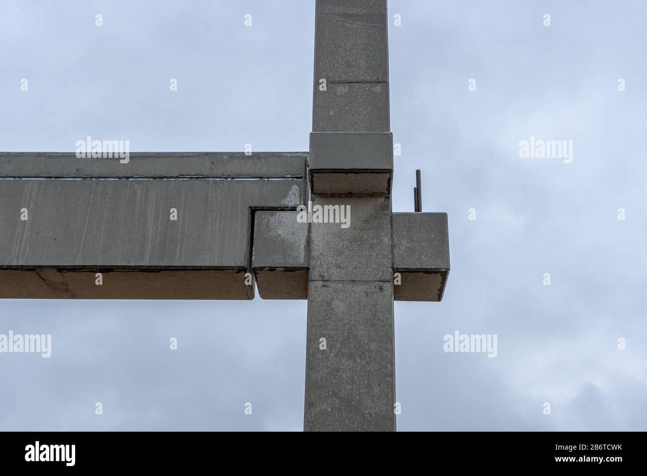 On a large construction site, concrete cross beams are connected to ...