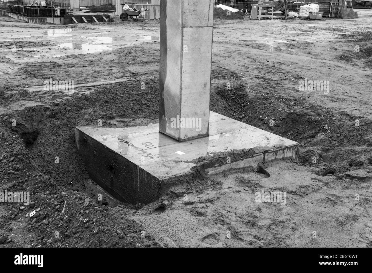 Concrete columns for a factory building are erected on a large ...