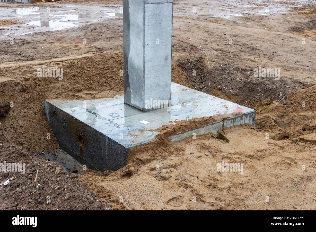 Concrete columns for a factory building are erected on a large ...