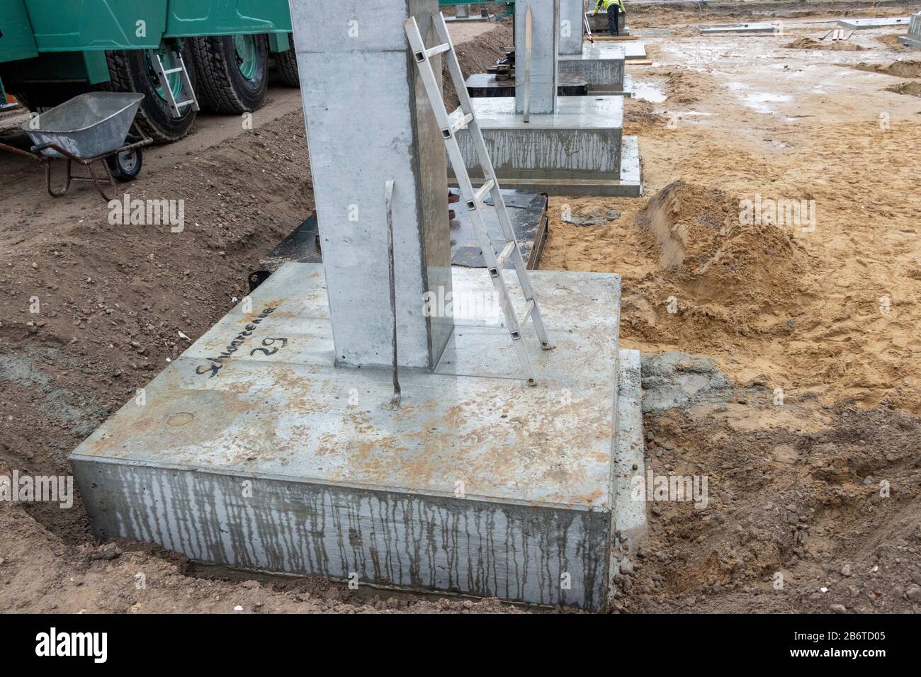 Concrete columns for a factory building are erected on a large ...