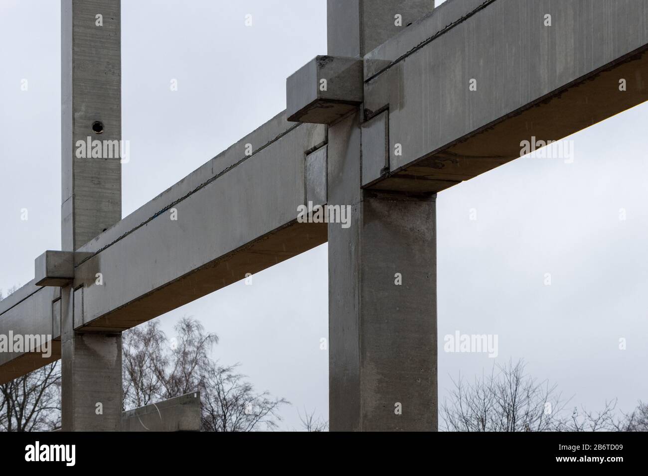 On a large construction site, concrete cross beams are connected to ...