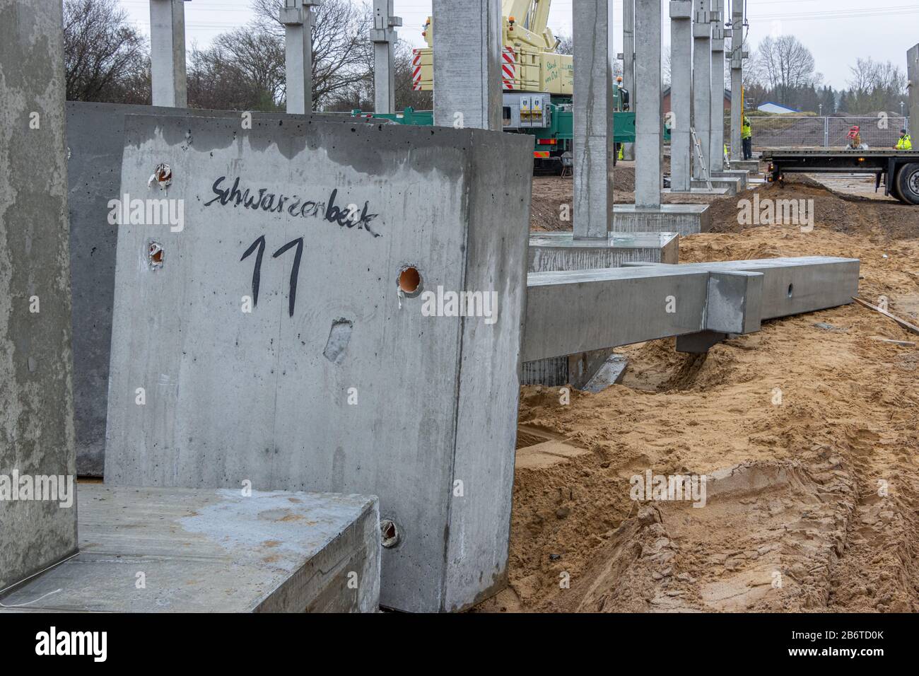 Concrete columns for a factory building are erected on a large ...