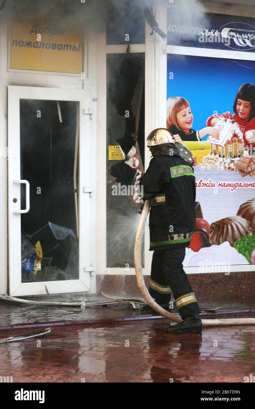 Burning building in the city. Fire extinguishing operation Stock Photo ...
