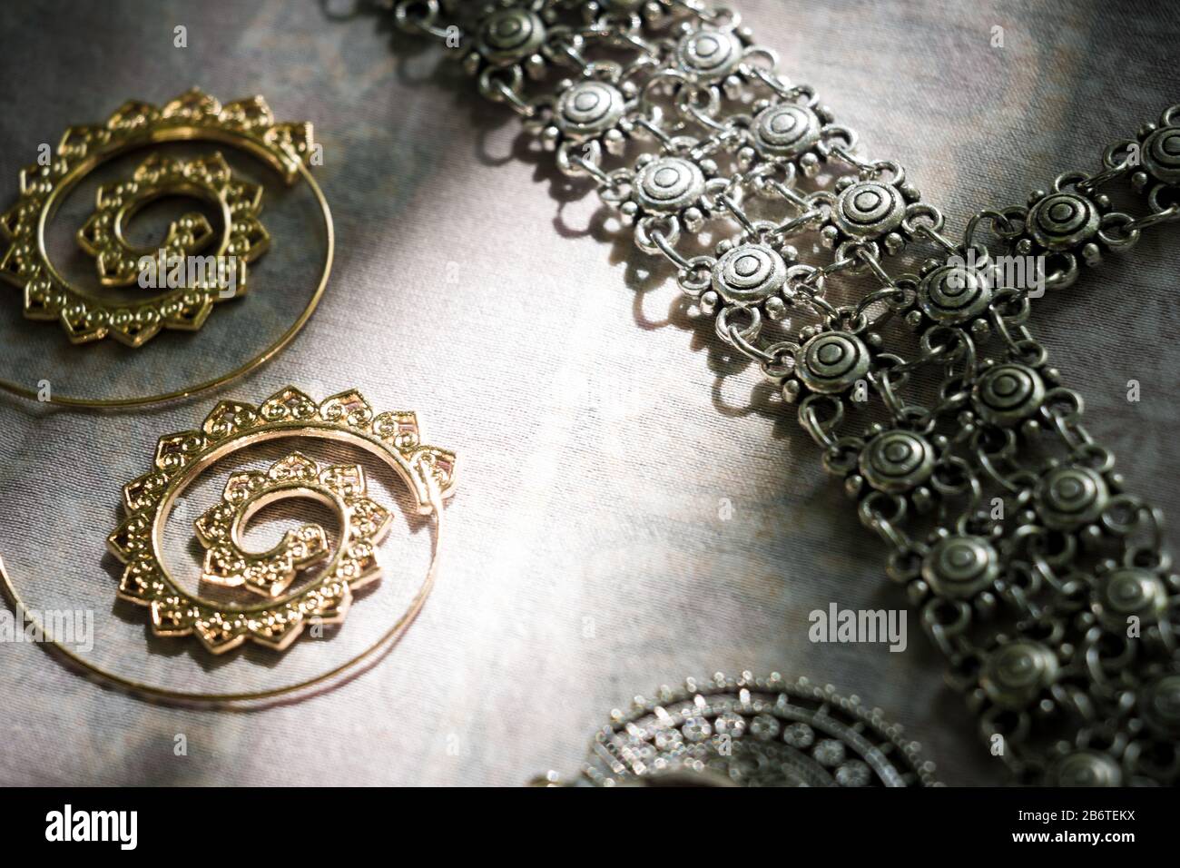 Golden and silver jewelry on a white background Stock Photo - Alamy