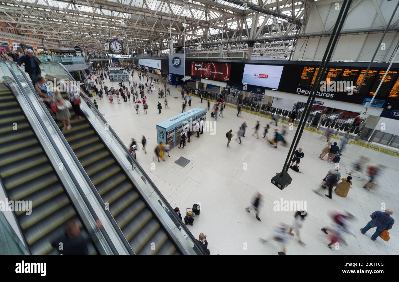 Blurred movement of rail travelers as they move to and fro across the ...