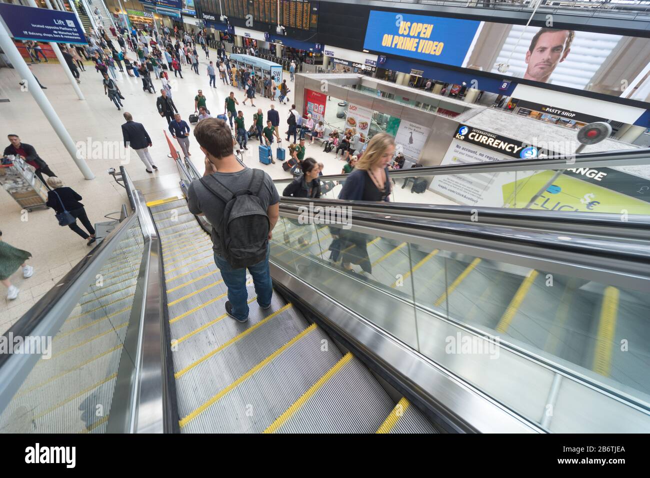 Train customers a Waterloo train station use the escalators to get to ...