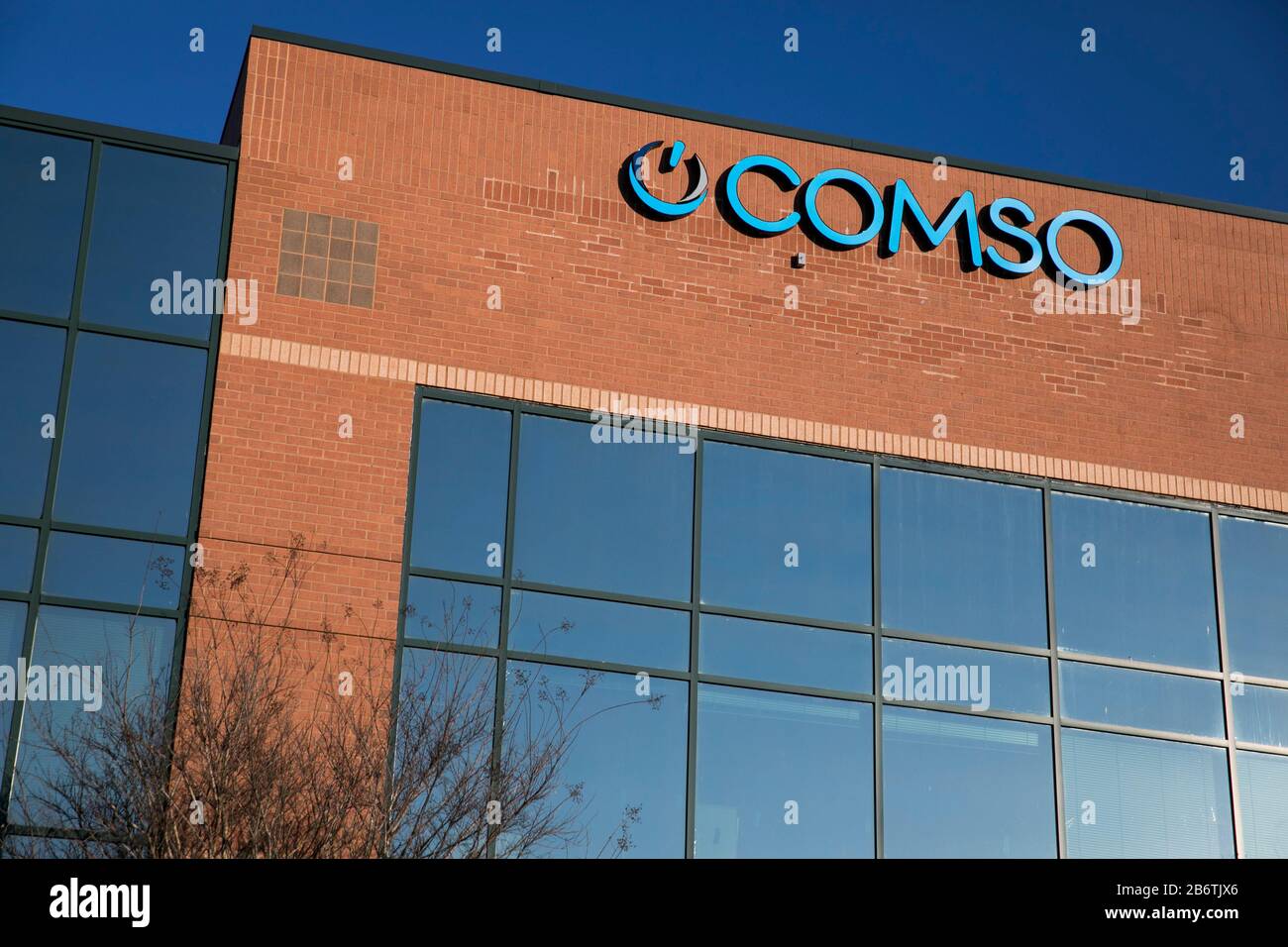 A logo sign outside of a facility occupied by Comso in Columbia ...