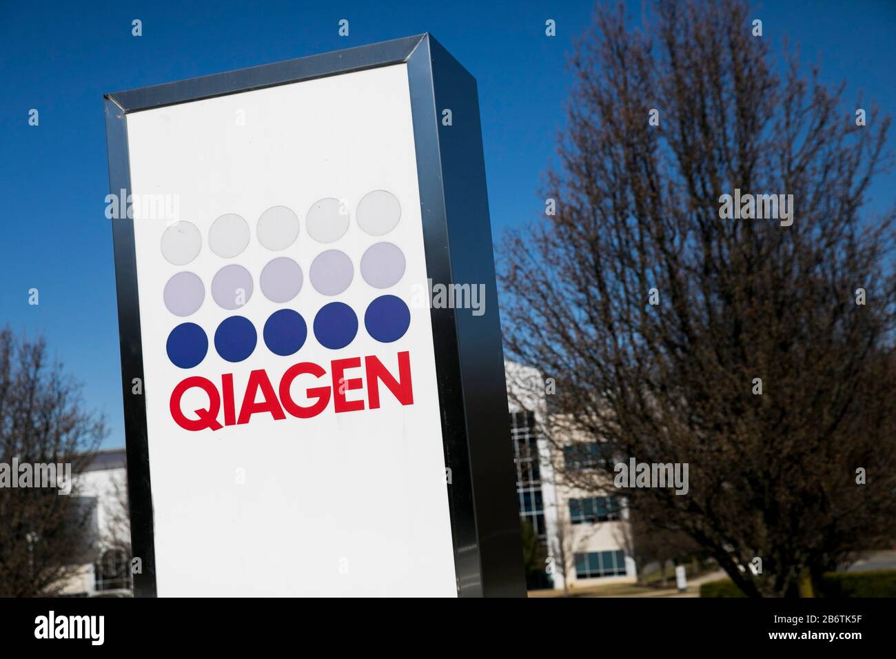 A logo sign outside of a facility occupied by QIAGEN in Germantown ...