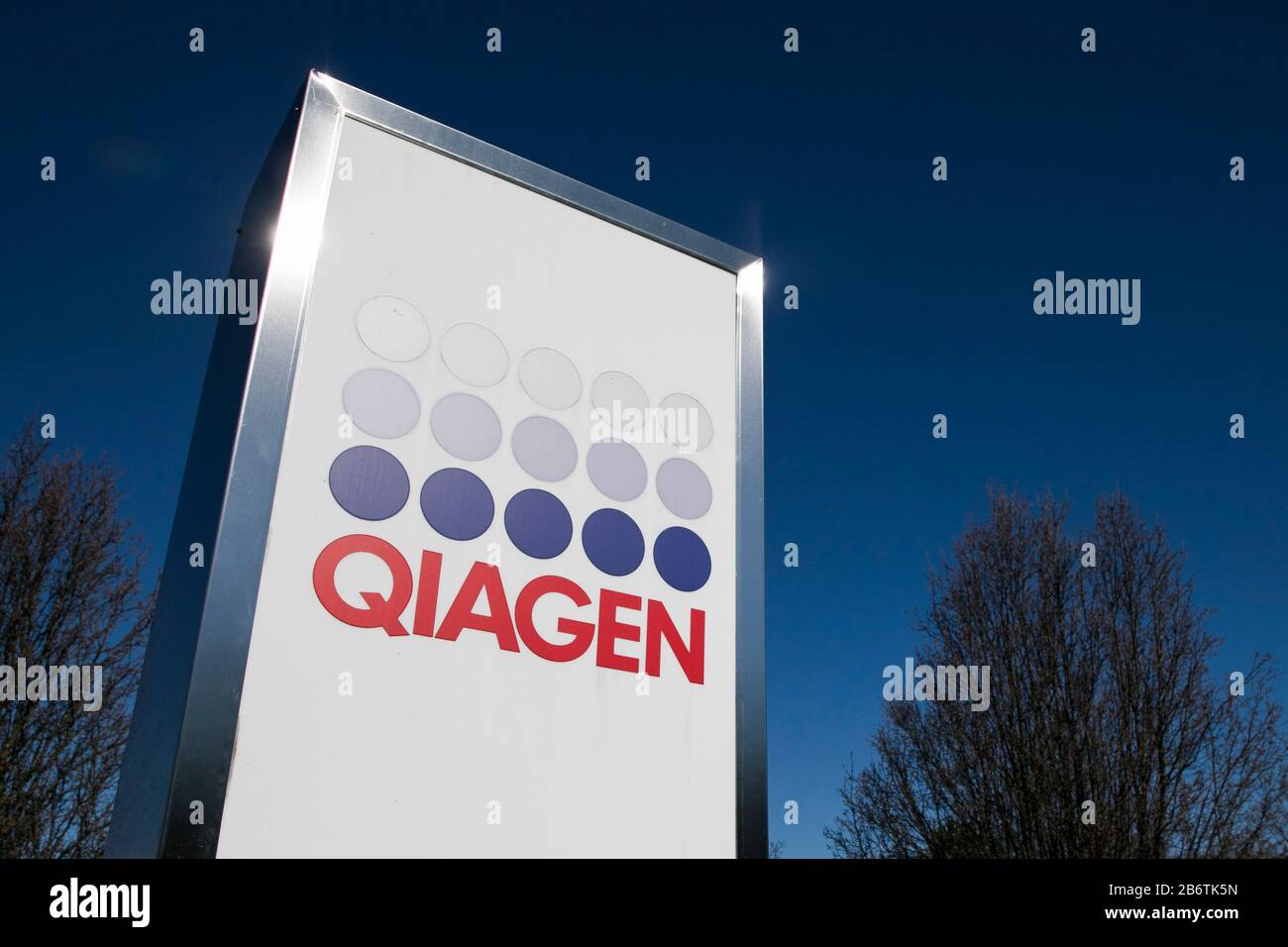 A logo sign outside of a facility occupied by QIAGEN in Germantown ...