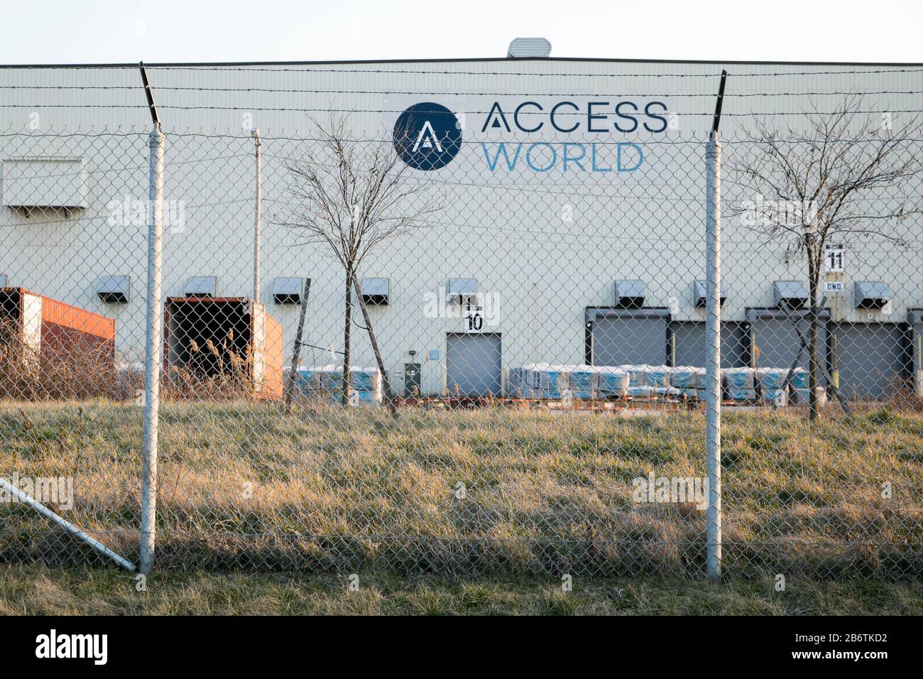 A logo sign outside of a facility occupied by Access World in Edgemere ...