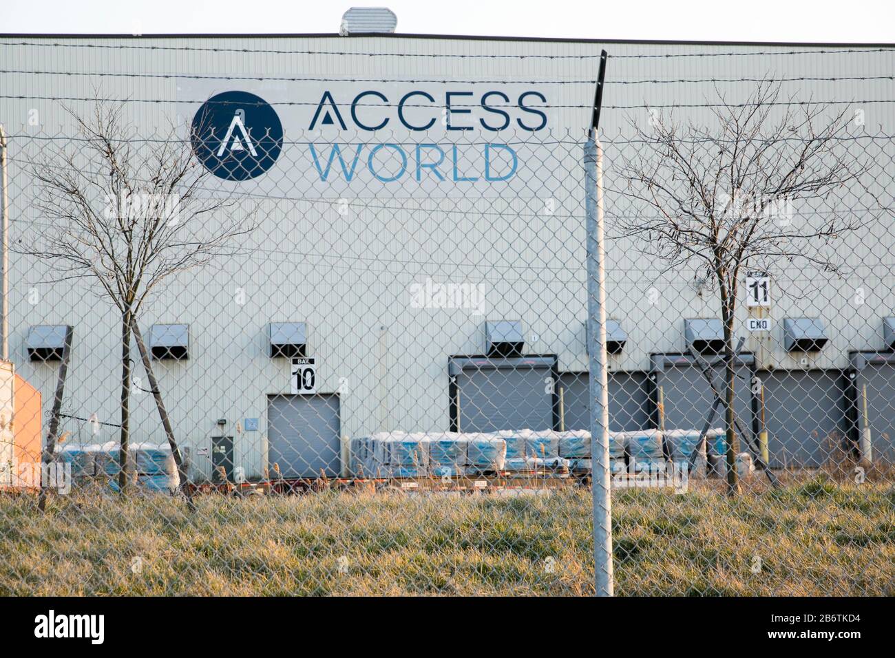 A logo sign outside of a facility occupied by Access World in Edgemere ...