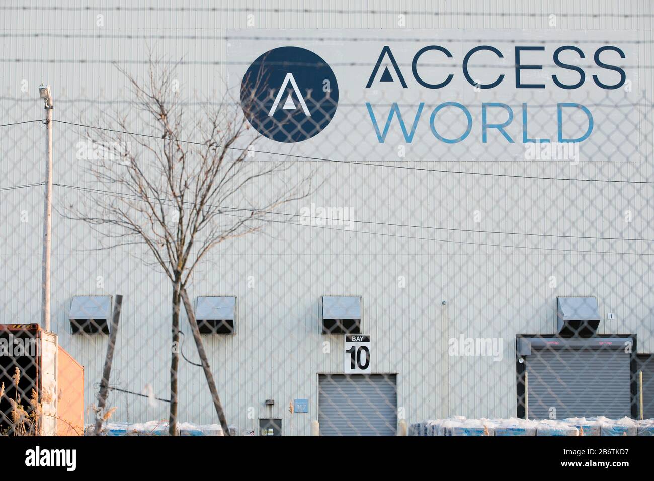 A logo sign outside of a facility occupied by Access World in Edgemere ...