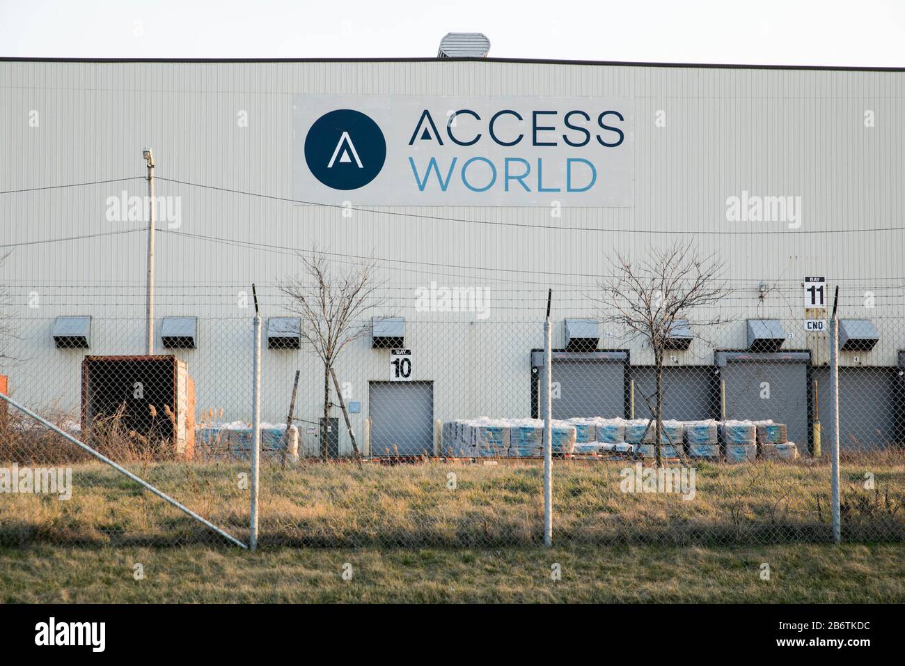 A logo sign outside of a facility occupied by Access World in Edgemere ...