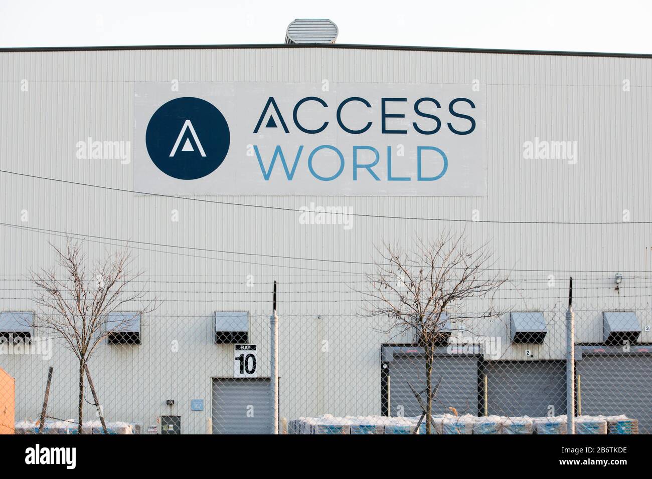 A logo sign outside of a facility occupied by Access World in Edgemere ...