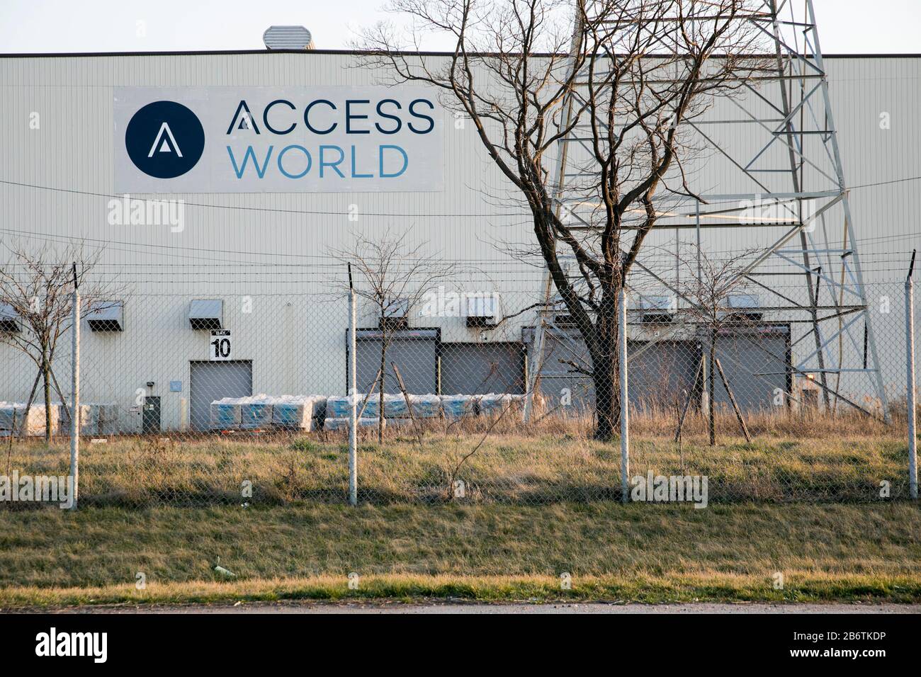 A logo sign outside of a facility occupied by Access World in Edgemere ...