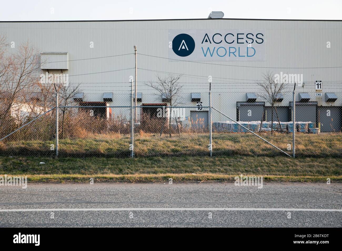 A logo sign outside of a facility occupied by Access World in Edgemere ...