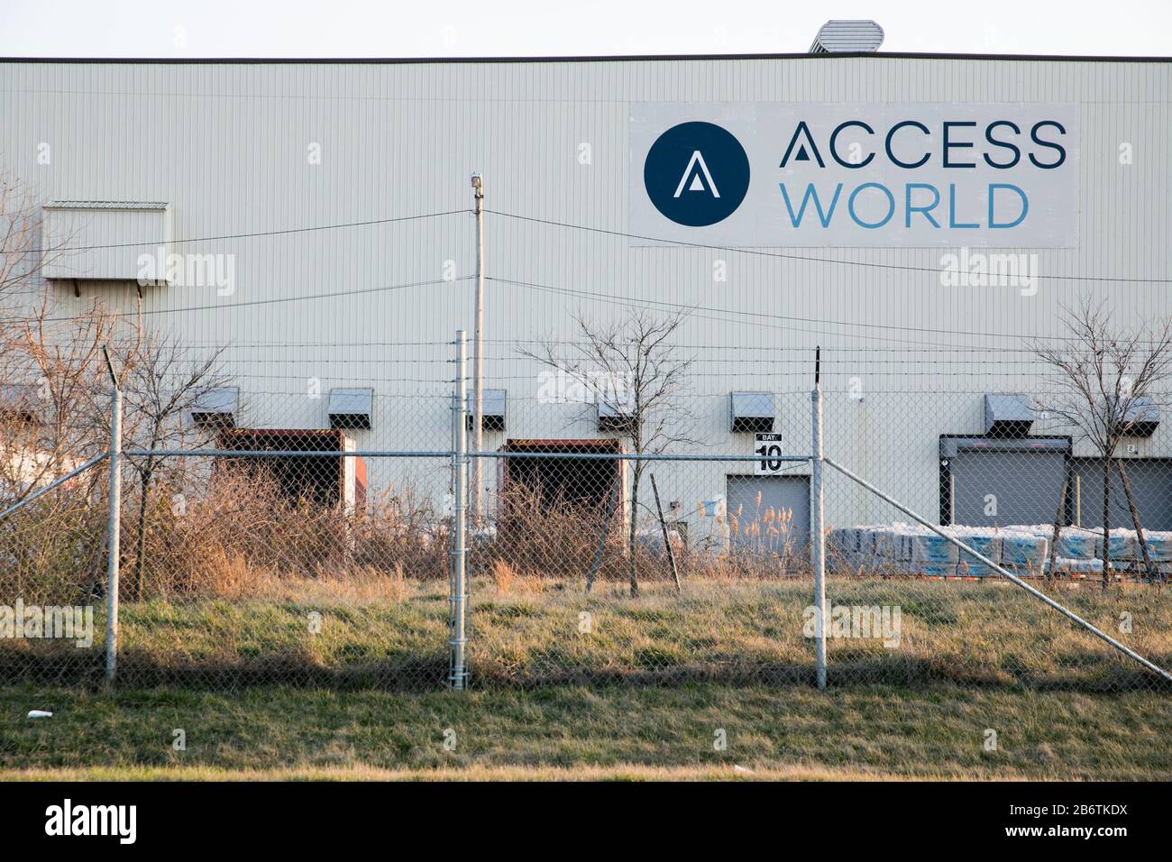 A logo sign outside of a facility occupied by Access World in Edgemere ...