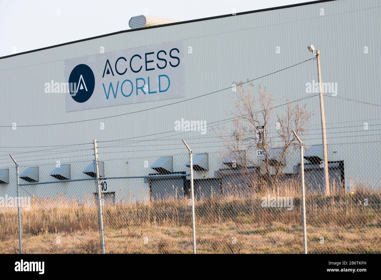A logo sign outside of a facility occupied by Access World in Edgemere ...