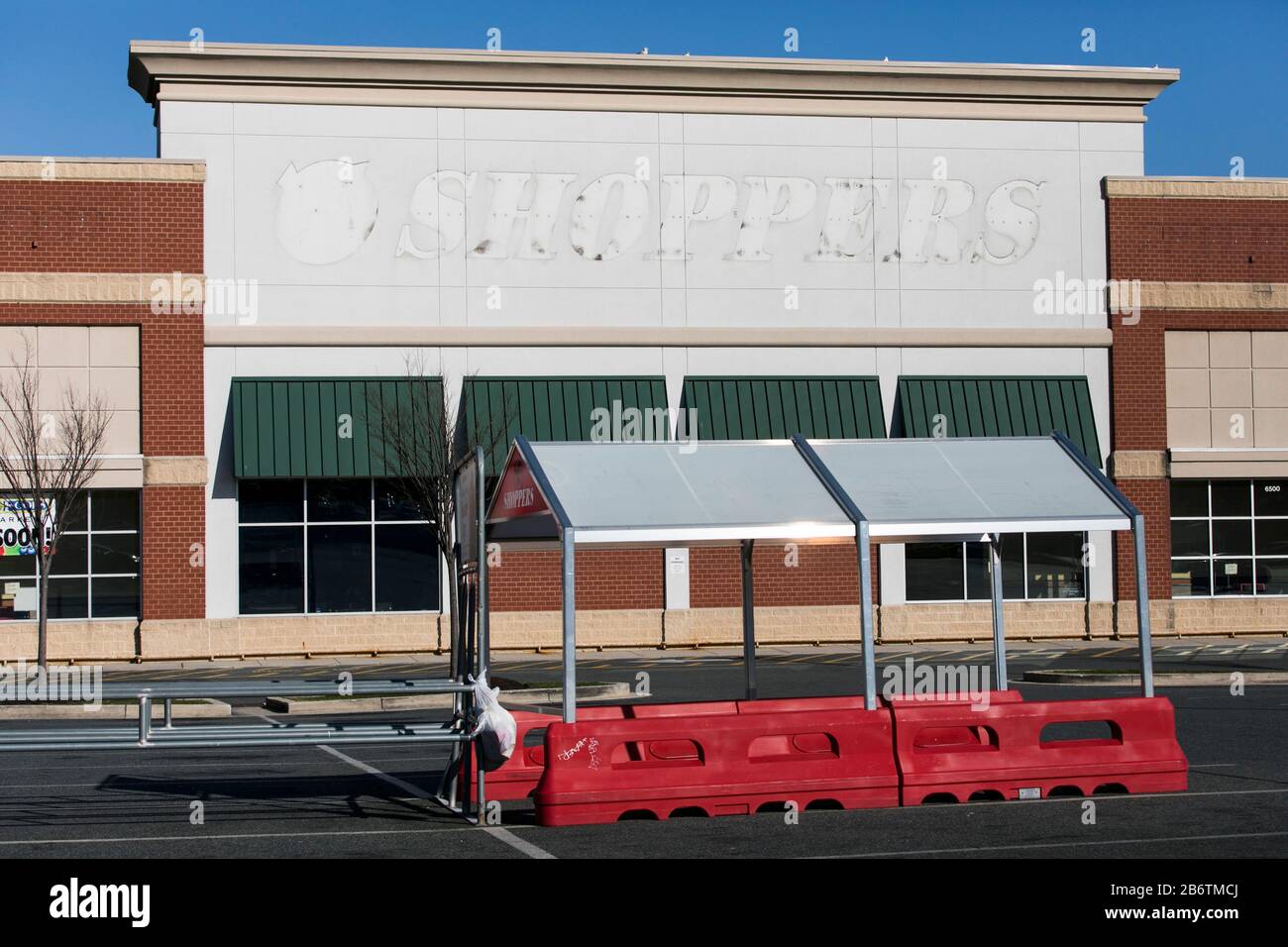 The faded outline of a logo sign outside of a closed and abandoned ...