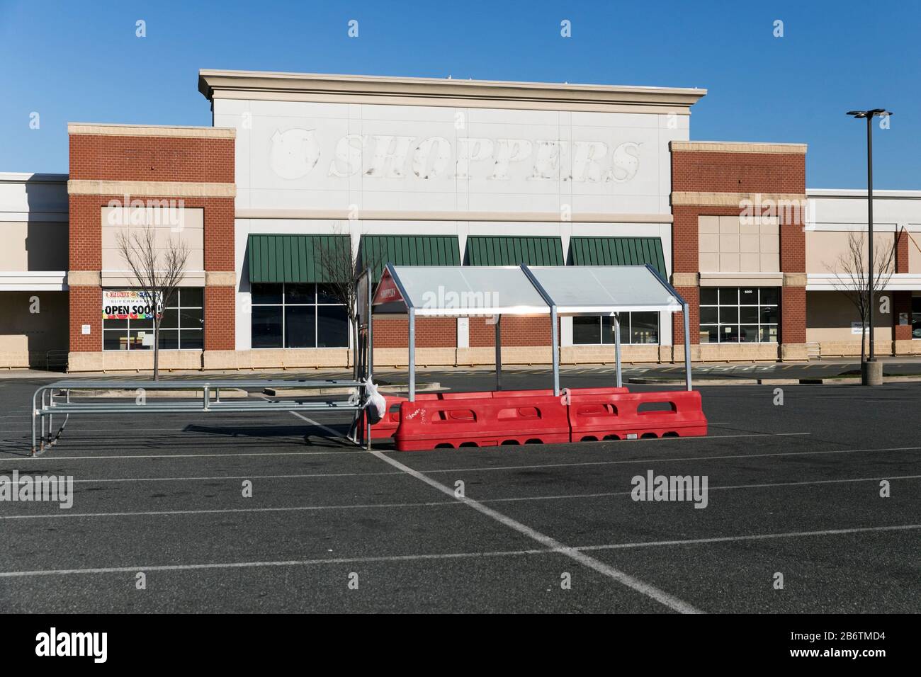The faded outline of a logo sign outside of a closed and abandoned ...