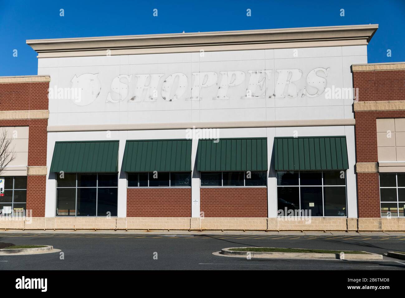 The faded outline of a logo sign outside of a closed and abandoned ...