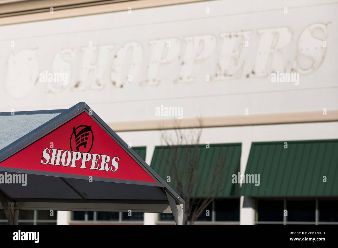 The faded outline of a logo sign outside of a closed and abandoned ...