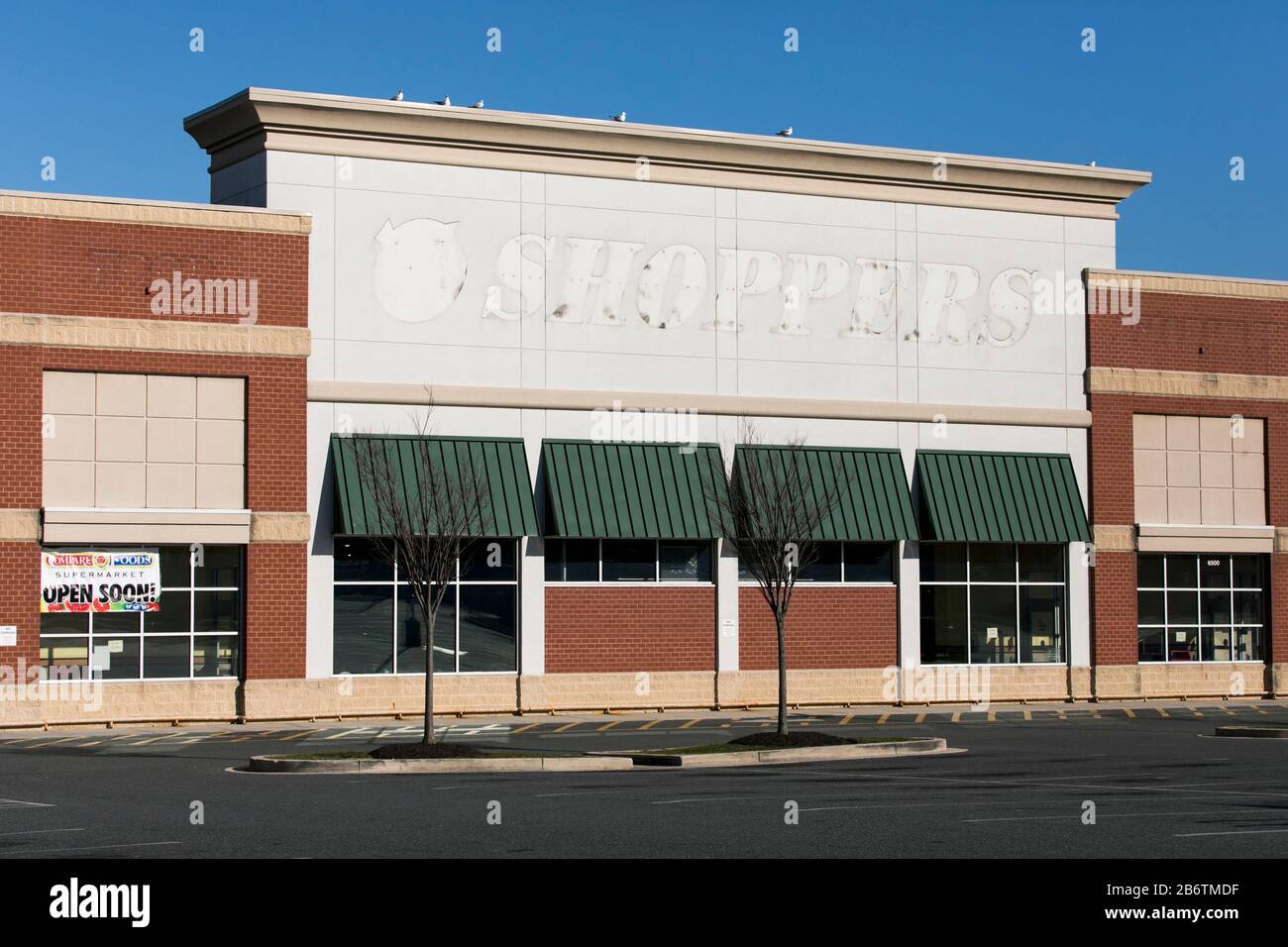 The faded outline of a logo sign outside of a closed and abandoned ...