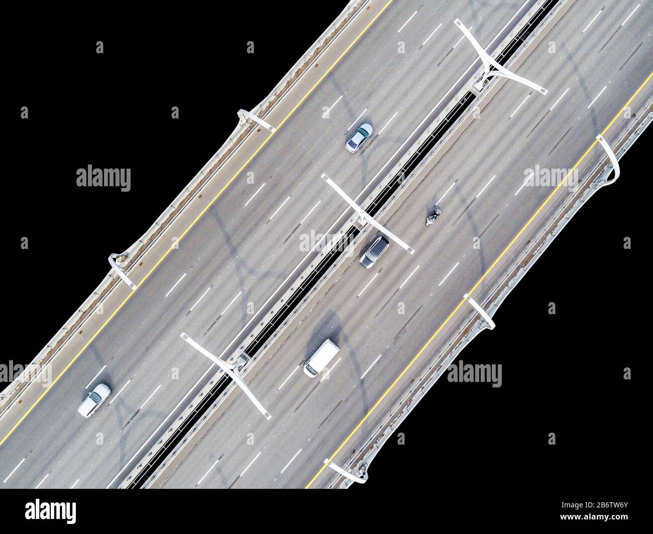 Aerial view of highway in city isolated on black background. Cars crossing interchange overpass ...