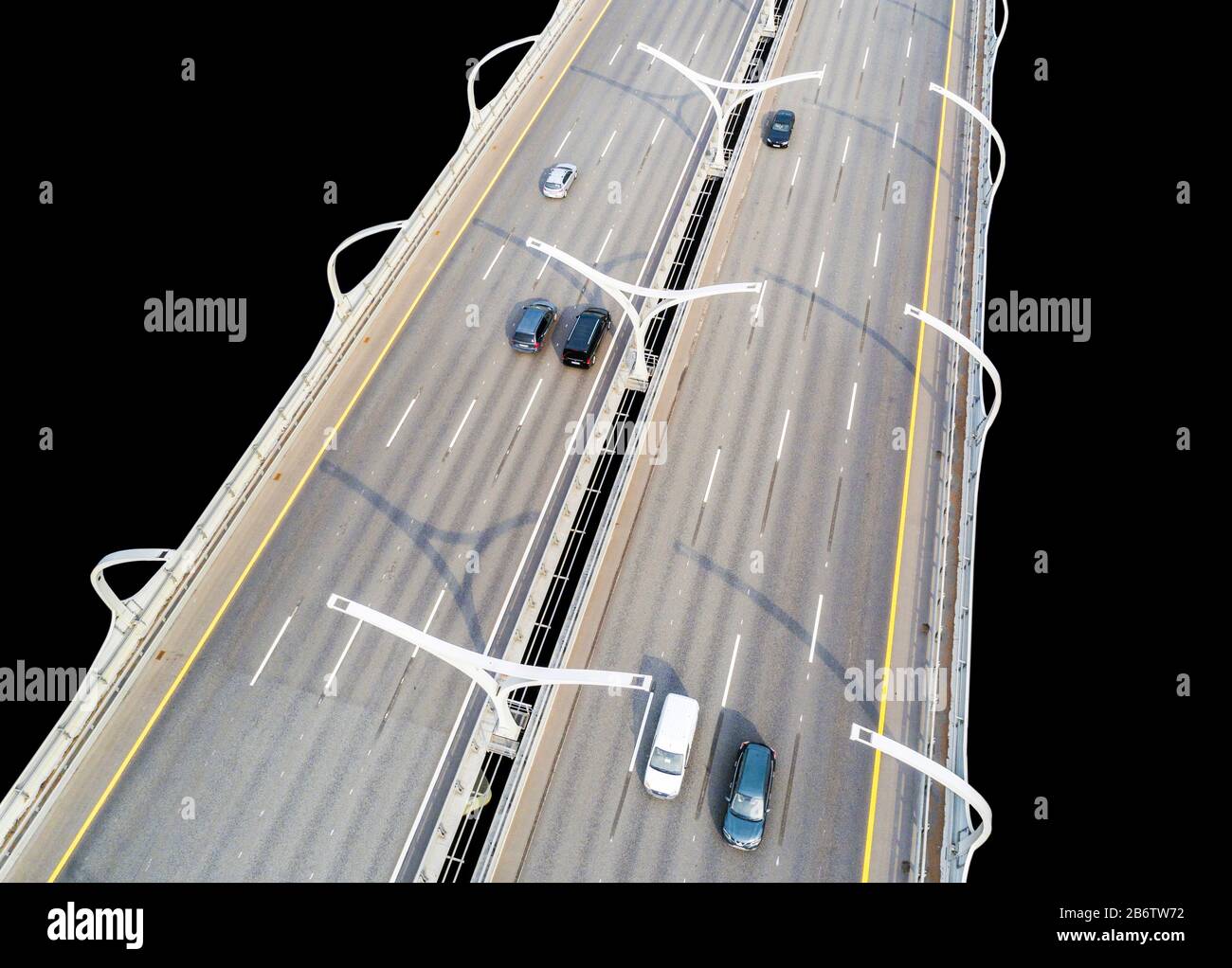 Aerial view of highway in city isolated on black background. Cars crossing interchange overpass ...