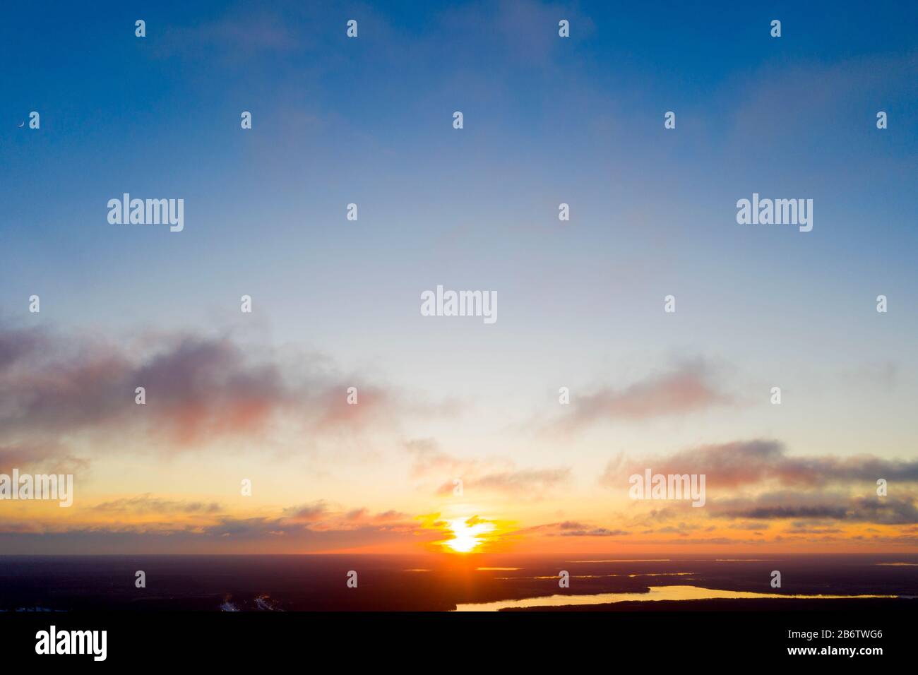 Aerial view sunset over the forest and lake. Top view. View from drone ...