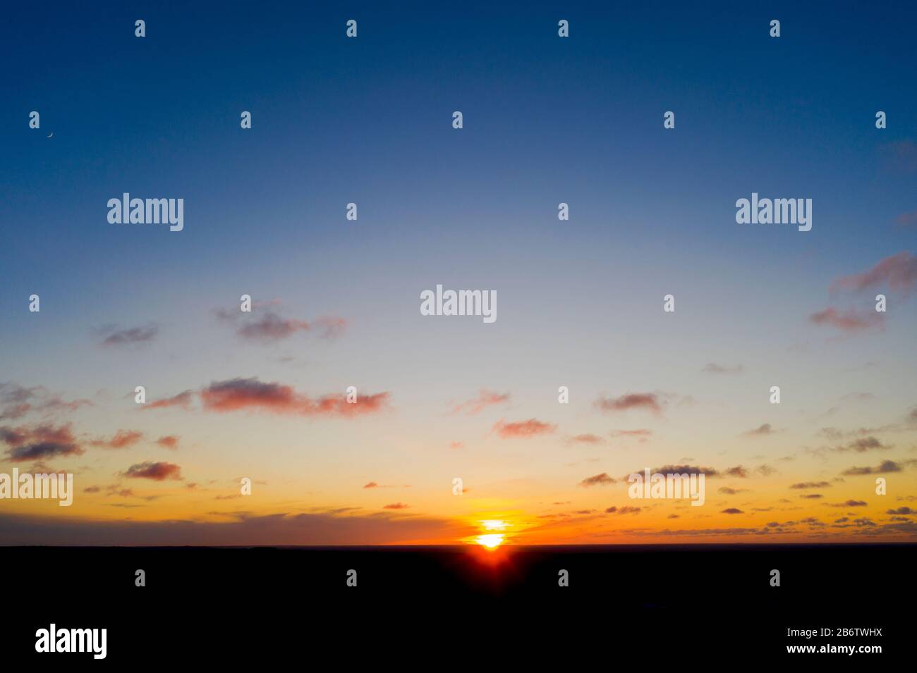 Aerial view sunset over the forest and lake. Top view. View from drone ...