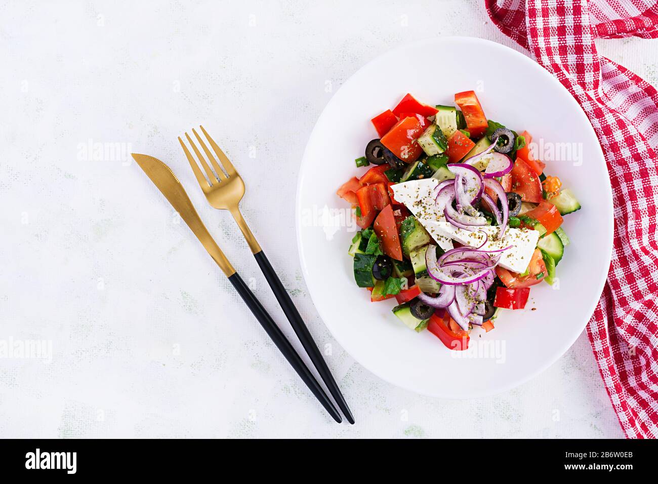 Trendy salad. Greek salad with fresh vegetables, feta cheese and black ...