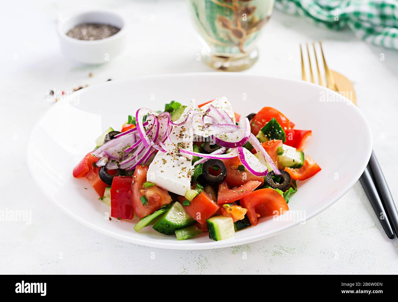 Trendy salad. Greek salad with fresh vegetables, feta cheese and black ...