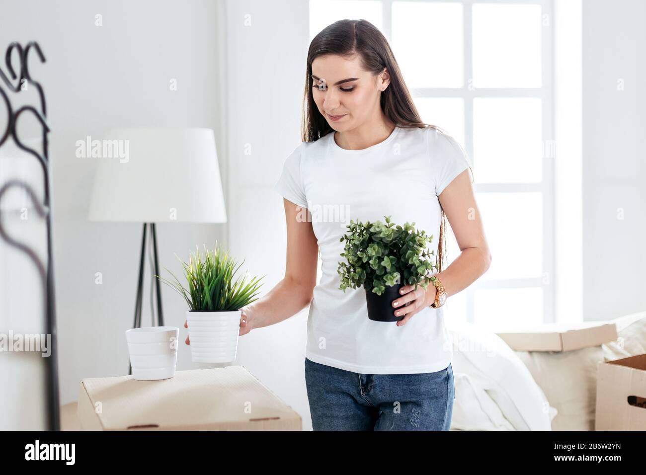 young woman placing her things in a new apartment Stock Photo - Alamy