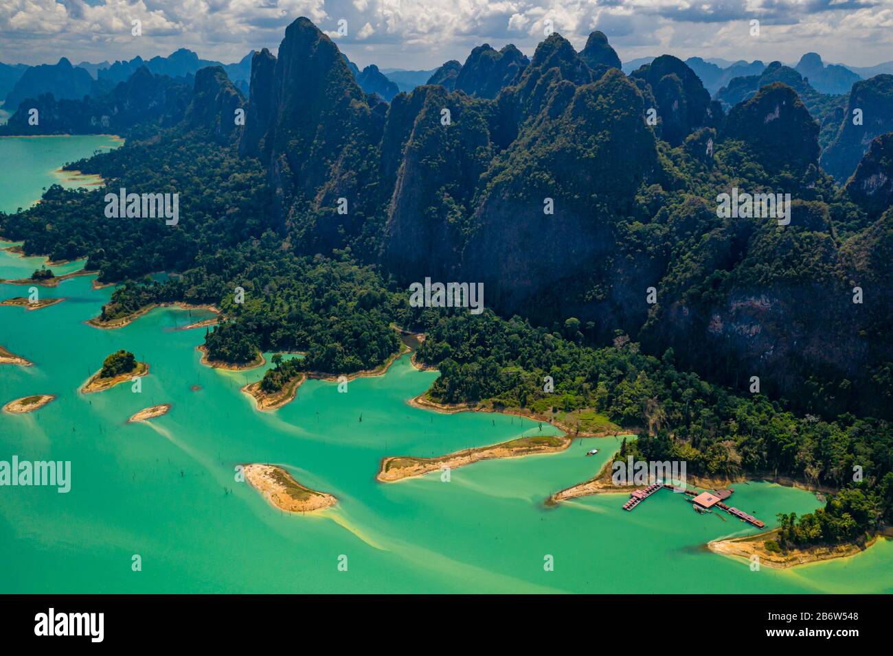 Aerial drone view looking down onto tiny, jungle covered islands in a ...