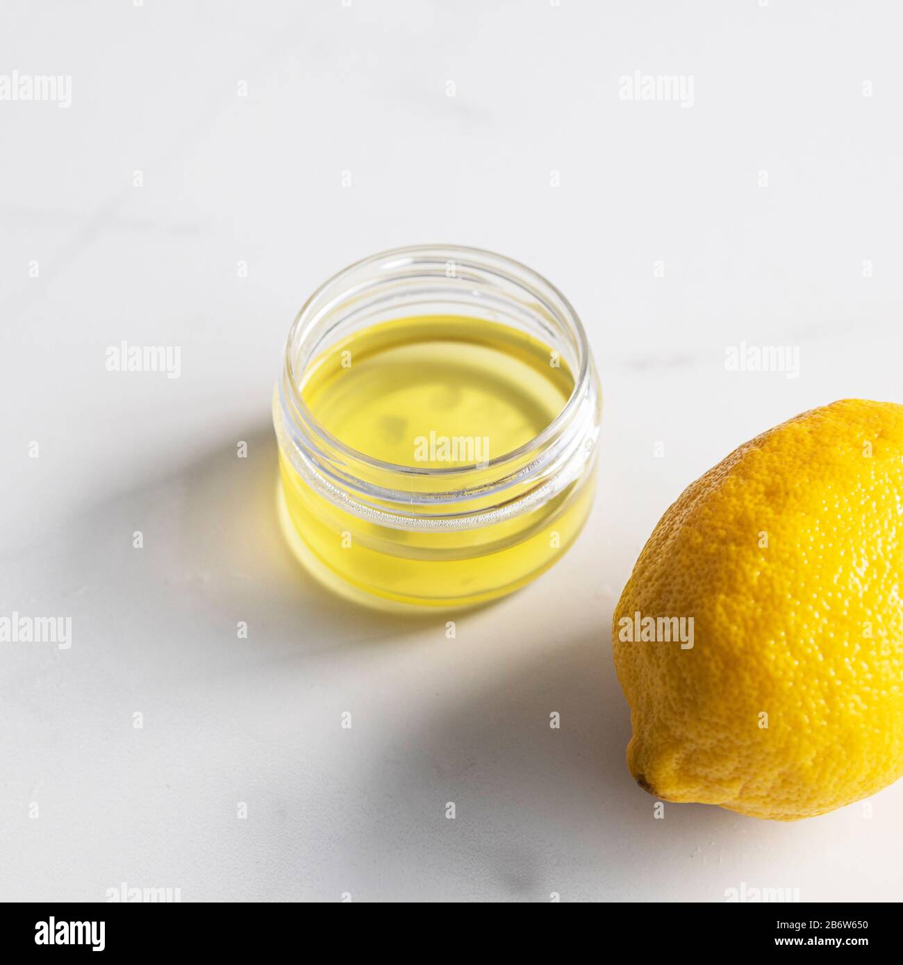 Cosmetic oil for body or face with lemon extract and citrus fruits on ...