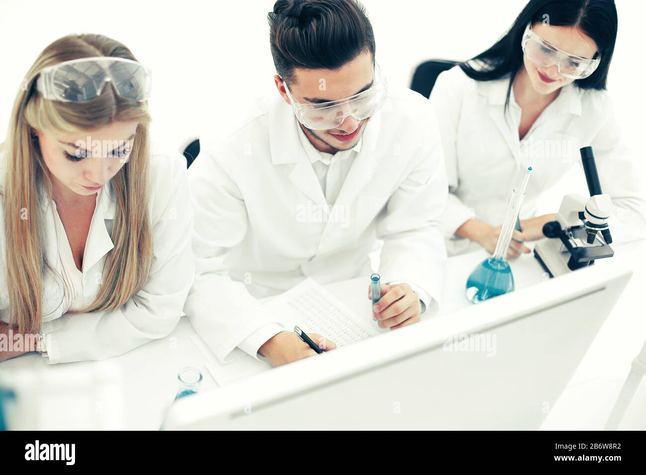 top view.a group of scientists working on a computer in the labo Stock ...