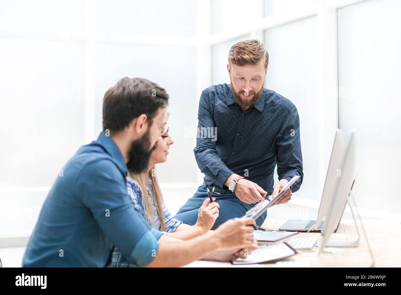 project Manager explaining to the staff the current task Stock Photo ...