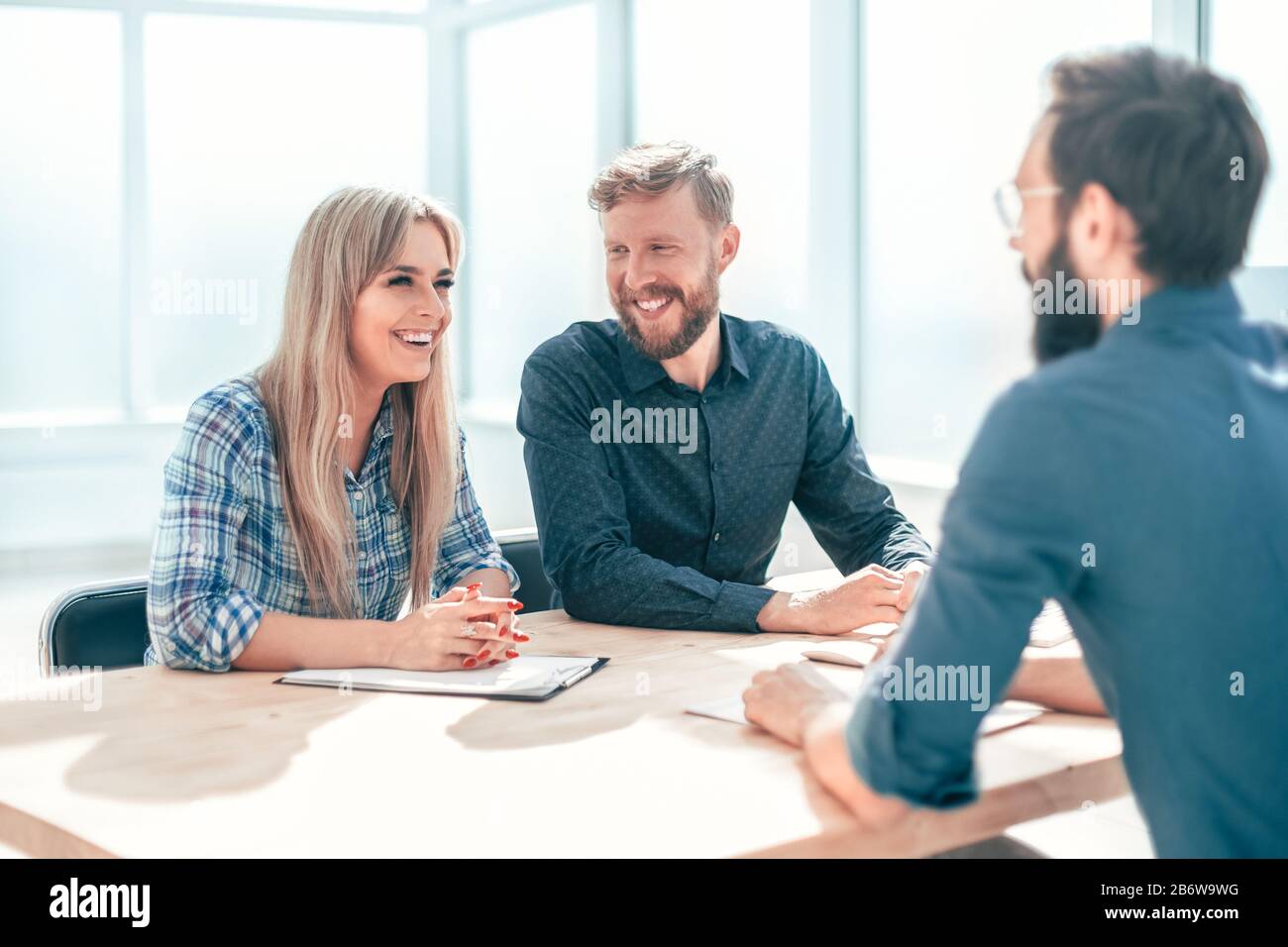 group of business people sitting at the office table Stock Photo - Alamy