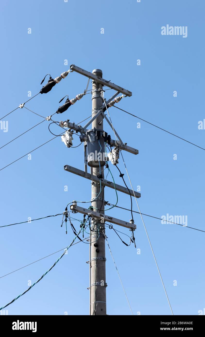 Electrical post with power line cables., against blue sky Stock Photo ...