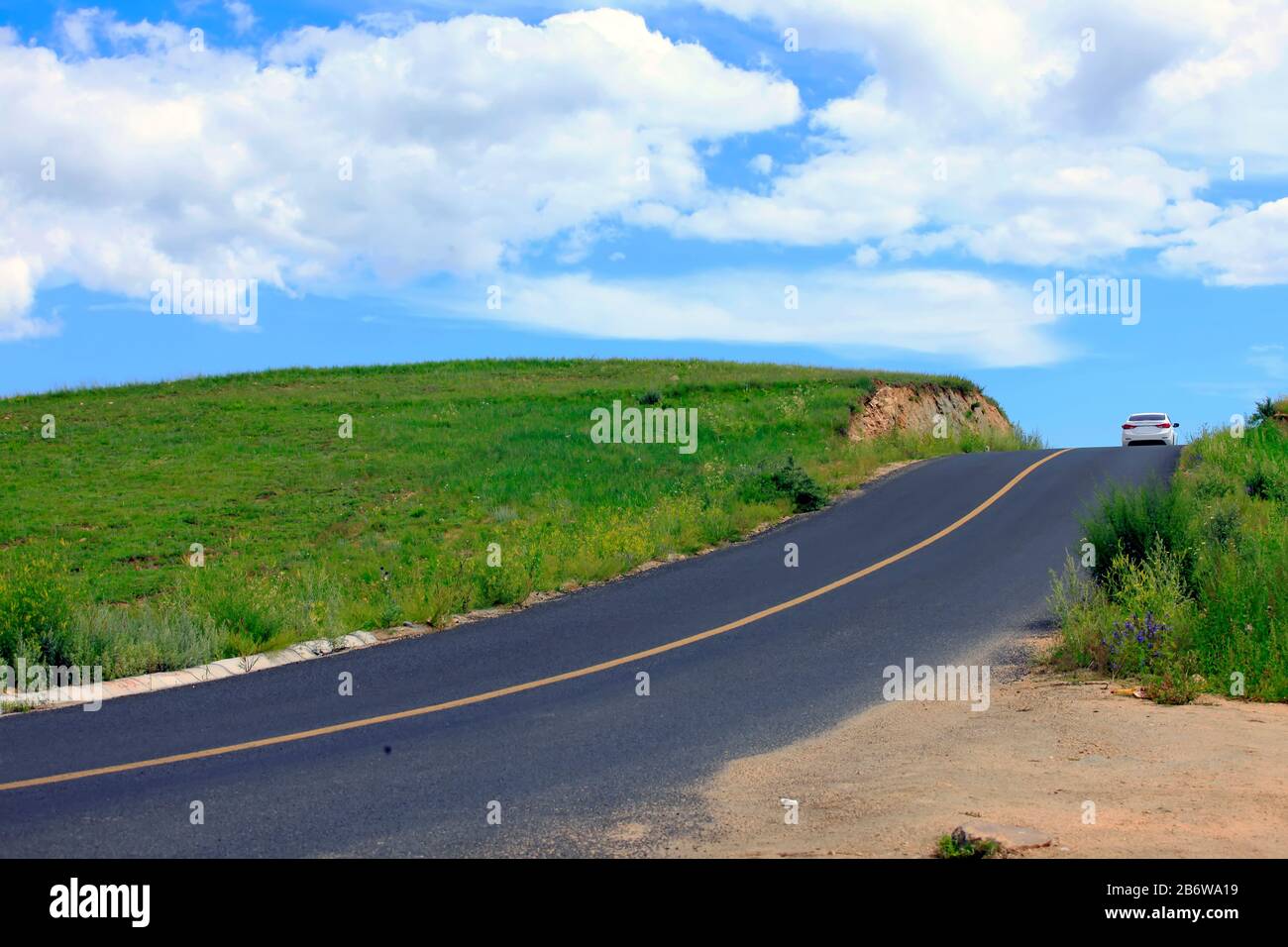 The asphalt road is on the prairie Stock Photo - Alamy