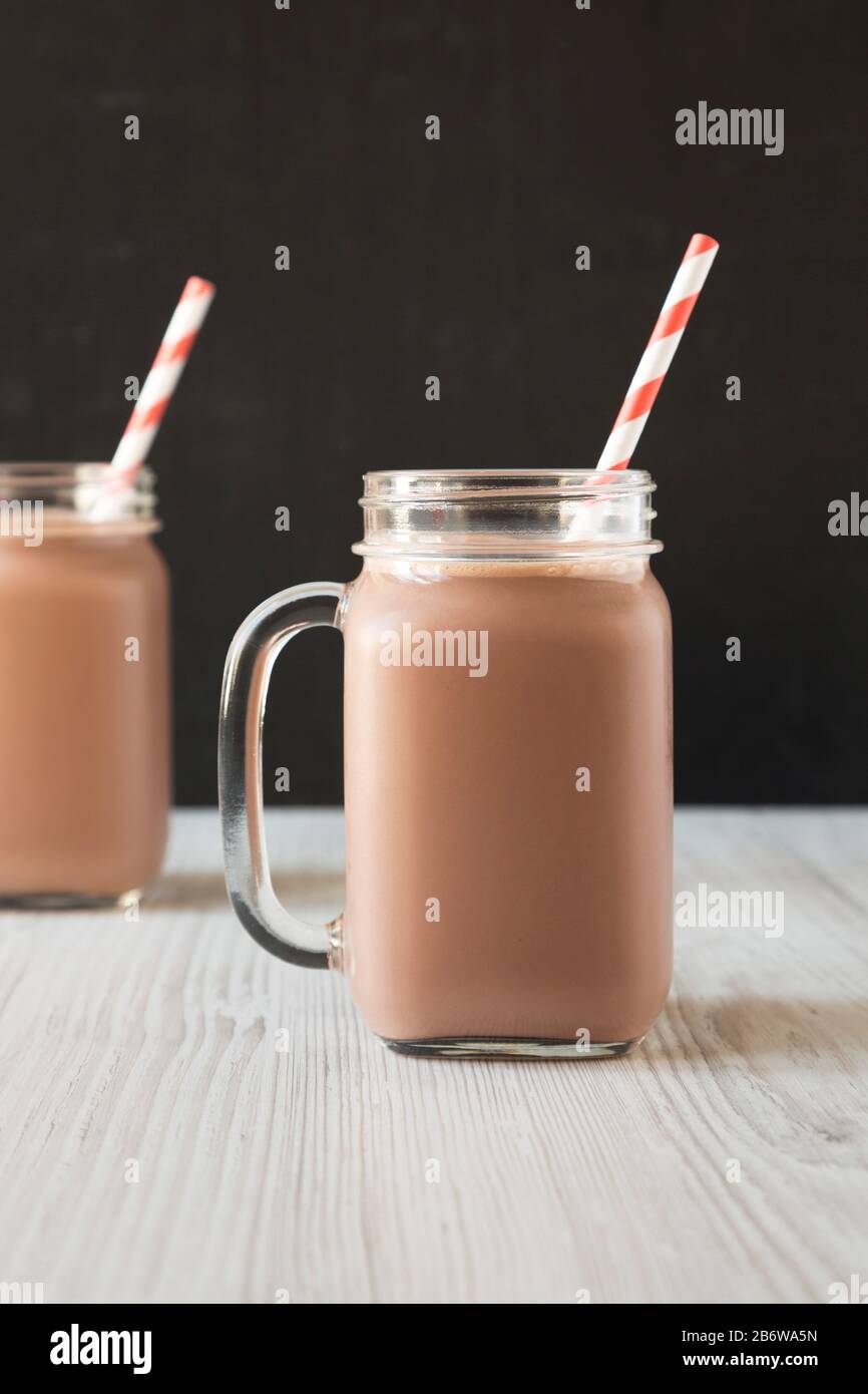Homemade New England Chocolate Milkshake in Glass Jar Mugs, side view ...