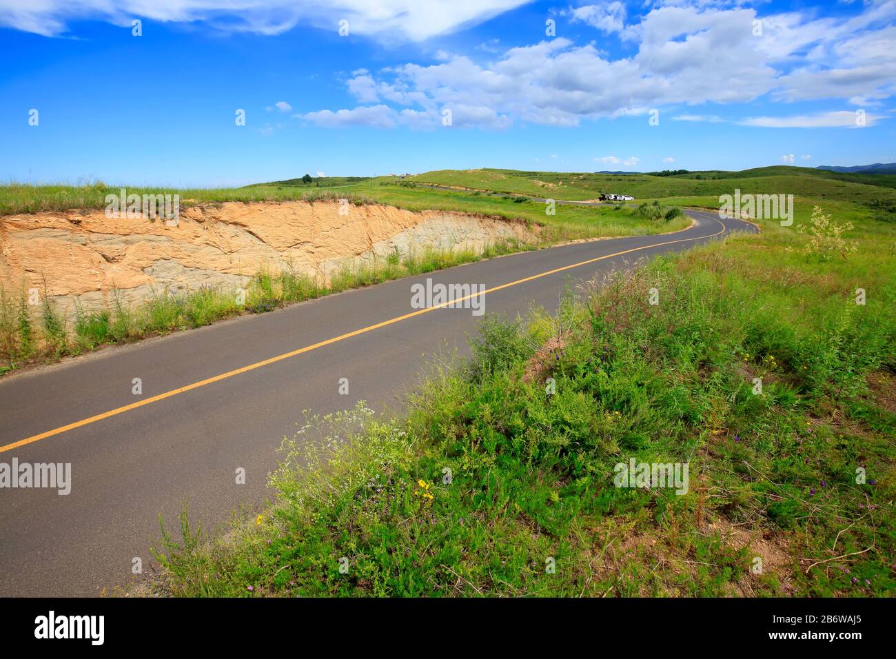 The asphalt road is on the prairie Stock Photo - Alamy